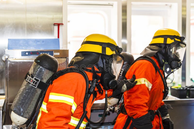 A Firefighters in Full Protective Gear, Mask, and Oxygen Tank Stands ...
