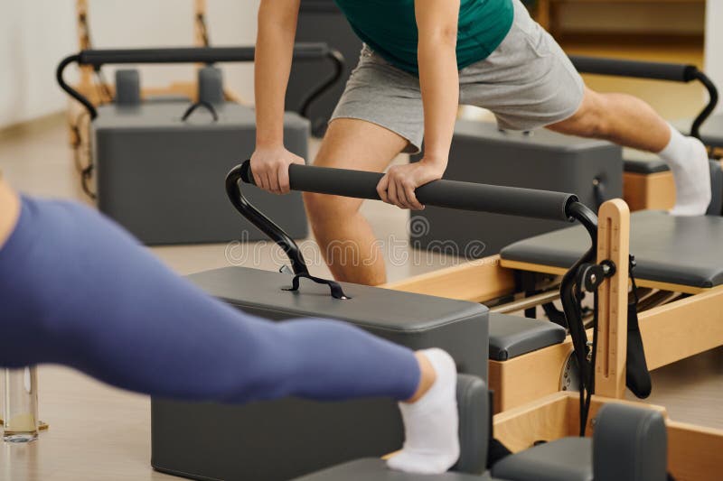 Engaging in Dynamic Pilates Exercises at Stock Photo - Image of core ...