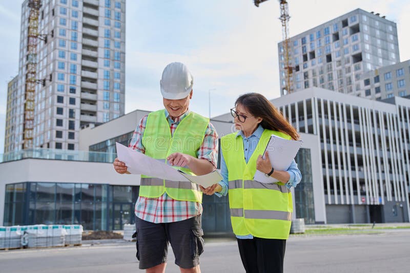 Two Industrial Construction Workers Discussing Project Plan for ...