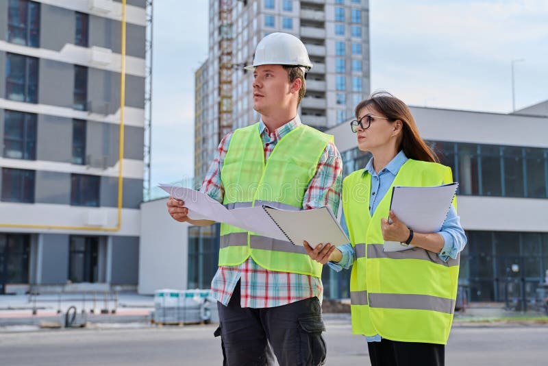 Two Industrial Construction Workers Discussing Project Plan for ...