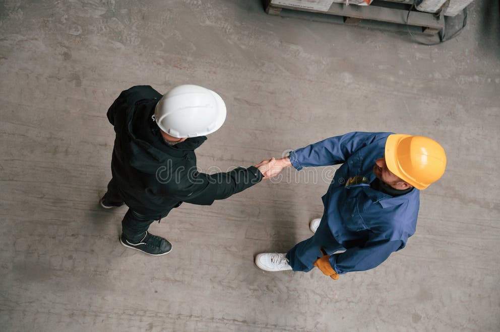 Two Industrial Workers are Doing Handshake. Top View Stock Photo ...