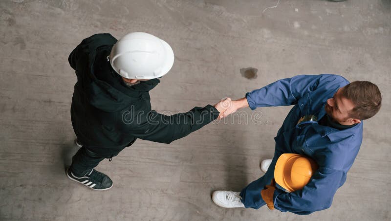 Two Industrial Workers are Doing Handshake. Top View Stock Image ...