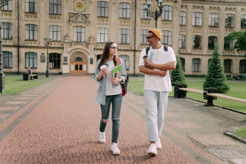 Two International Students, a Man and a Woman, Walk through the ...