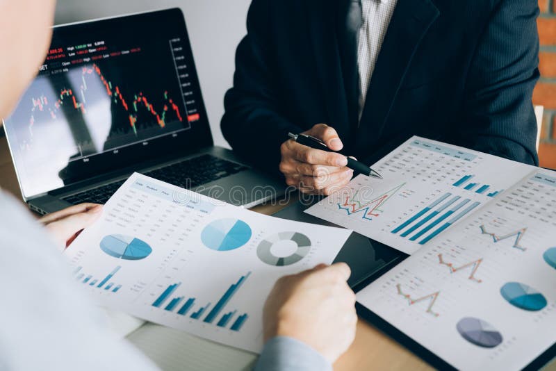 Two Investors are Working Together with Analyzing the Stock Data Graphs ...