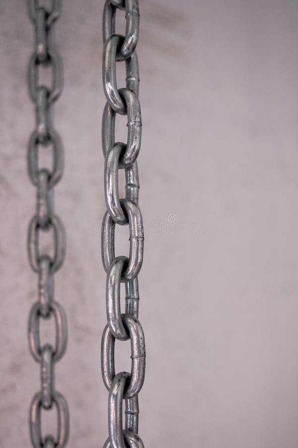 Two Iron Chains Hang Vertically on a Light Background Stock Photo ...