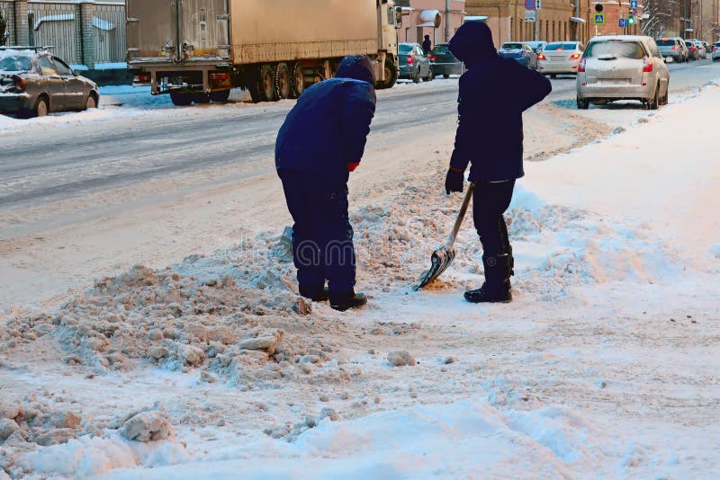 Two Janitors Cleaning Snow on the Sidewalk with Shovels Stock Image ...