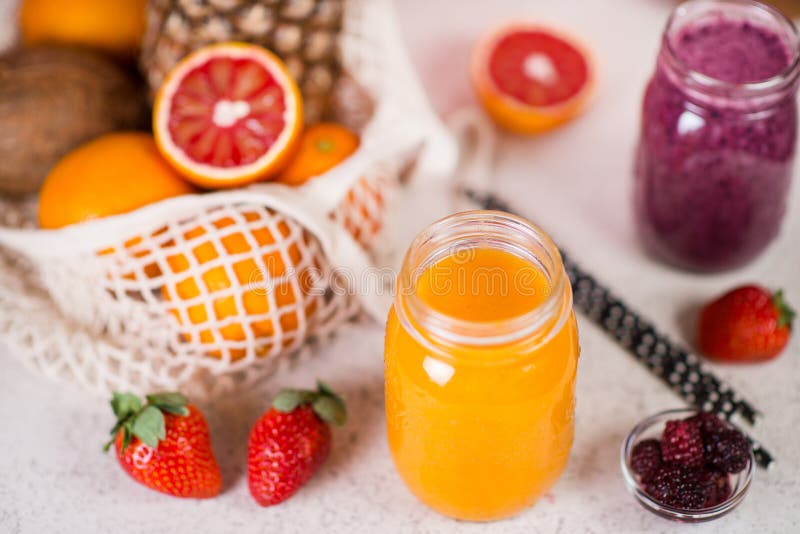 Two Jars of Multi-colored Smoothie on a Pink Background Stock Photo ...