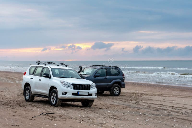 Two 4x4 Jeeps on the Seashore during the Sunset. Stock Image - Image of ...