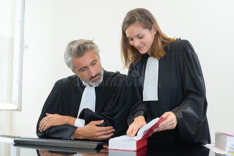 Two Judges Looking at Law Book Stock Photo - Image of mature, team ...