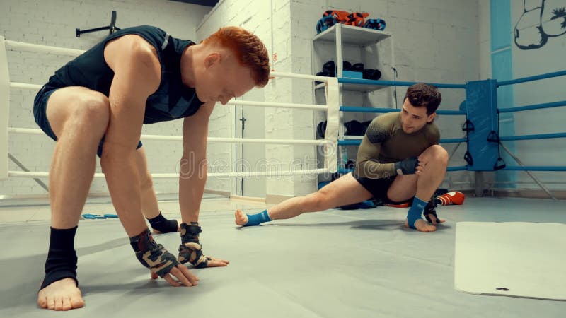 Two Kickboxer Stretching Legs while Preparing To Fight Training on Ring ...