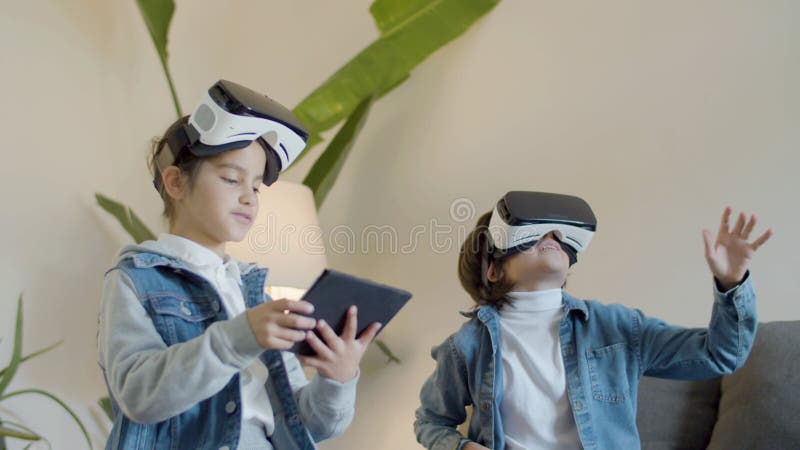 Two Kids Having Fun Playing with Virtual Reality Glasses Stock Video ...