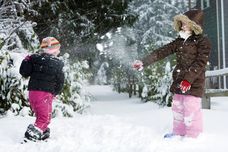 Two Kids Having a Snowball Fight Stock Image - Image of playing, kids ...