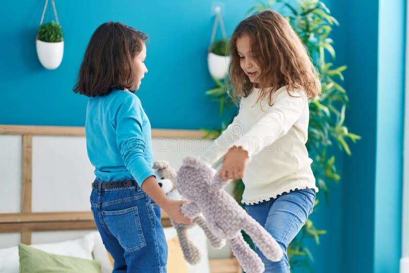 Two Kids Holding Teddy Bear Standing on Bed at Bedroom Stock Image ...