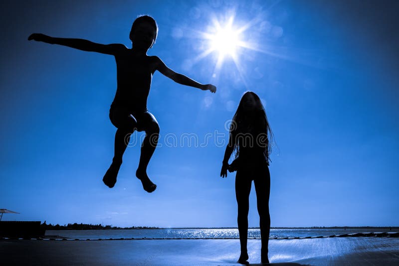 Two Kids Jumping on Trampoline Stock Image - Image of silhouette ...