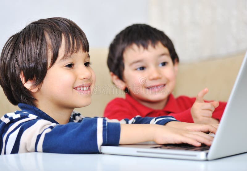Two kids with laptop stock photo. Image of education - 13978350