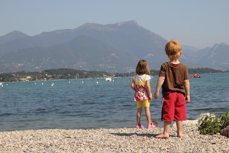 Two kids looking at a lake stock photo. Image of look - 24713574