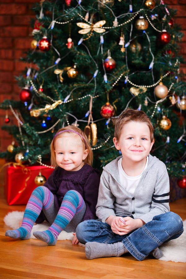 Two Kids Near Christmas Tree Stock Photo - Image of christmas, tree ...
