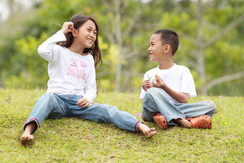 Two Kids Outdoor Having a Chat Stock Photo - Image of friendship ...