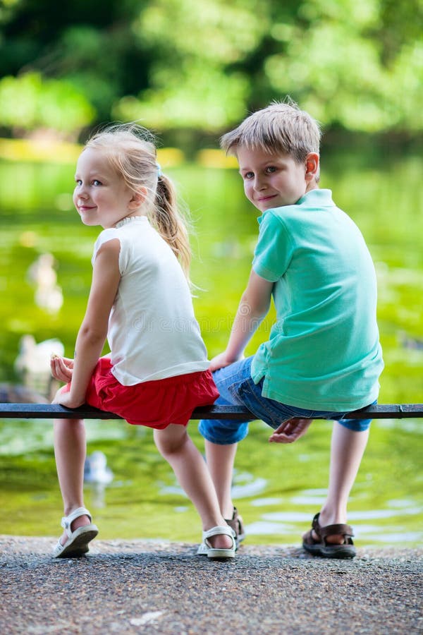 Two kids in a park stock image. Image of garden, play - 34729721
