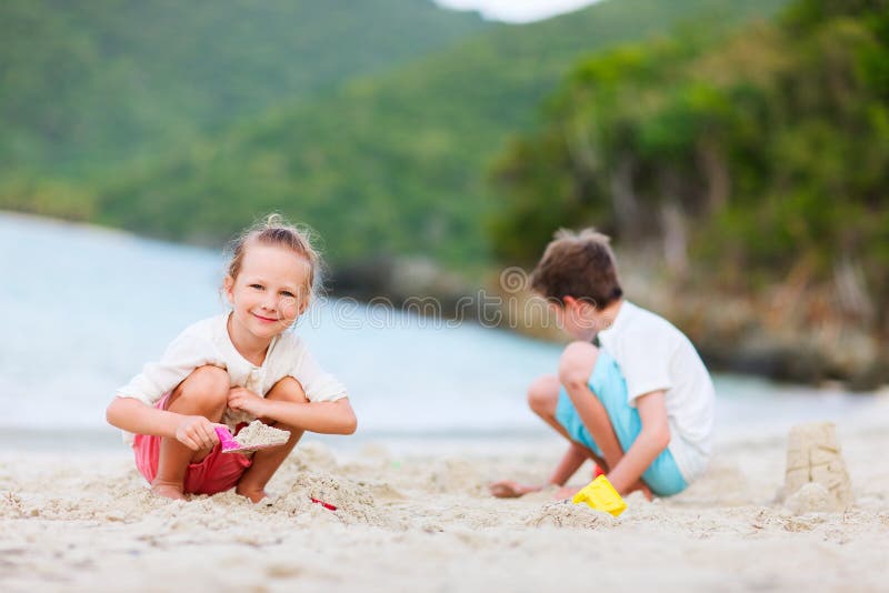 Two kids playing at beach stock photo. Image of coast - 47429786