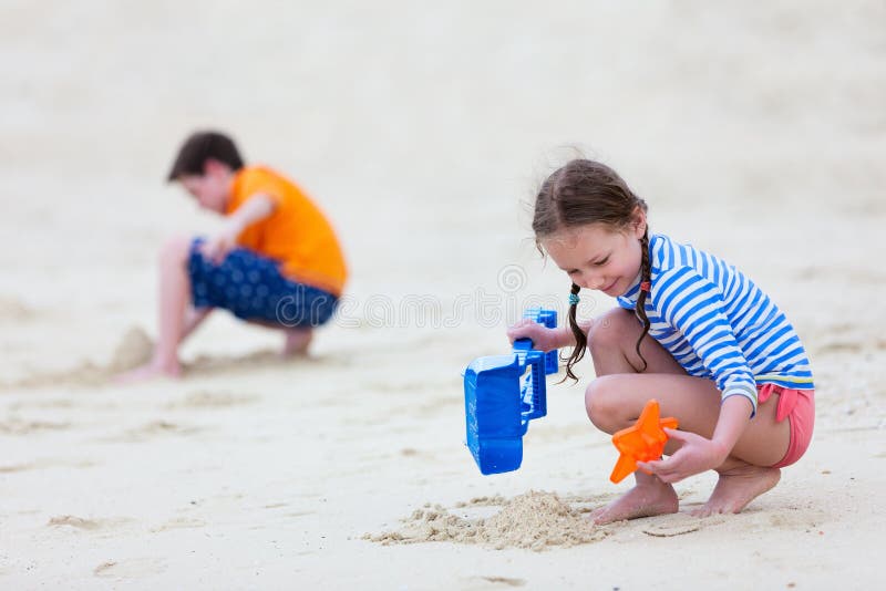 Two kids playing at beach stock photo. Image of summer - 52068192