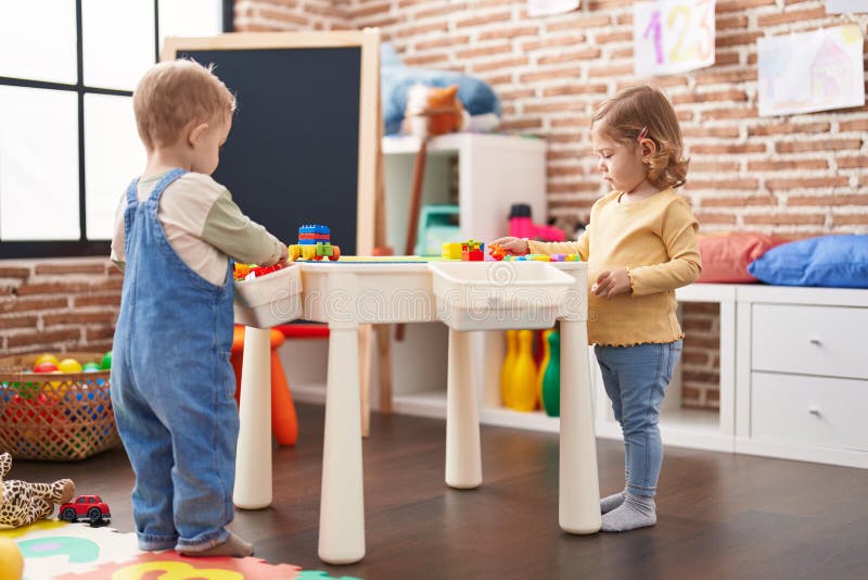 Two Kids Playing with Construction Blocks Standing at Kindergarten ...