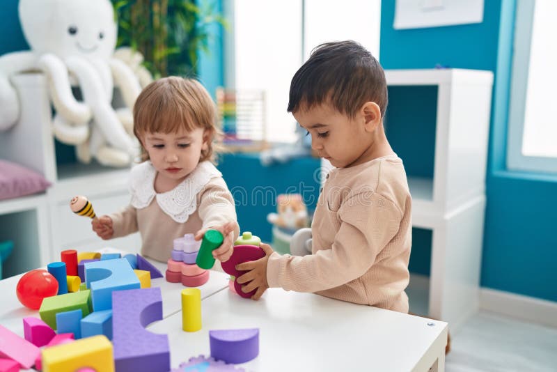 Two Kids Playing with Construction Blocks Standing at Kindergarten ...