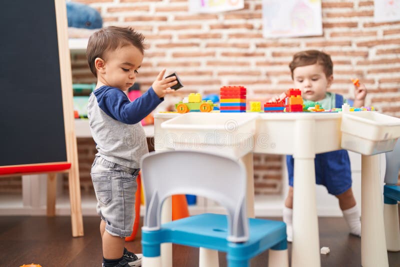 Two Kids Playing with Construction Blocks Standing at Kindergarten ...