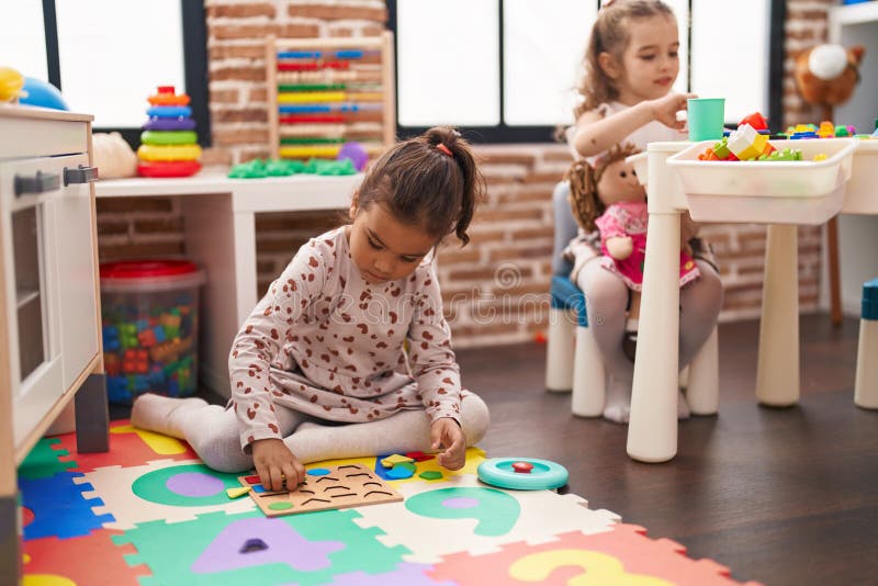 Two Kids Playing with Maths Puzzle Game and Doll Sitting on Floor at ...
