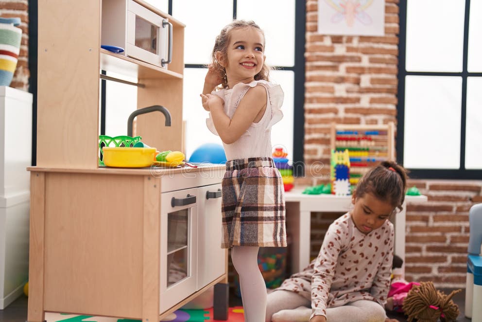 Two Kids Playing with Play Kitchen Standing at Kindergarten Stock Photo ...