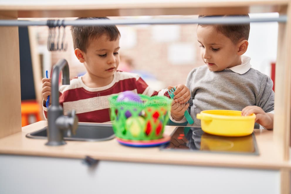 Two Kids Playing with Play Kitchen Standing at Kindergarten Stock Image ...