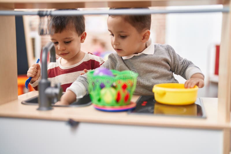Two Kids Playing with Play Kitchen Standing at Kindergarten Stock Image ...
