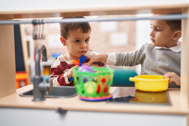 Two Kids Playing with Play Kitchen Standing at Kindergarten Stock Photo ...