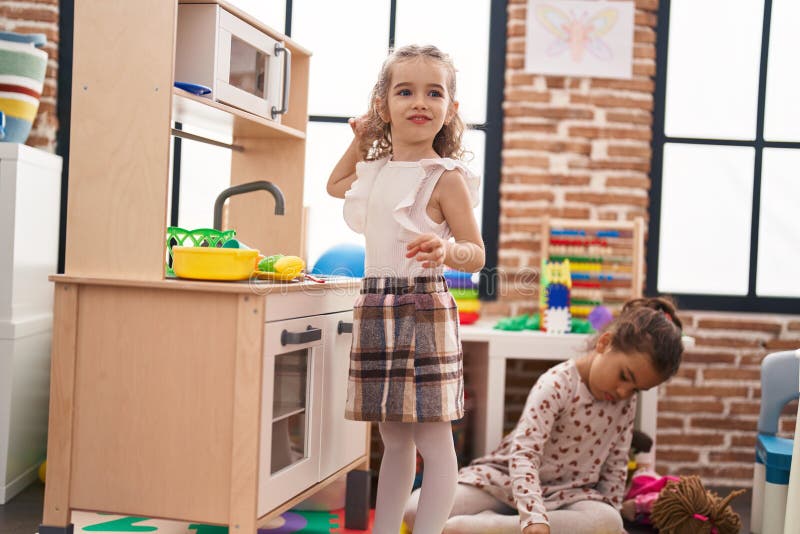 Two Kids Playing with Play Kitchen Standing at Kindergarten Stock Photo ...