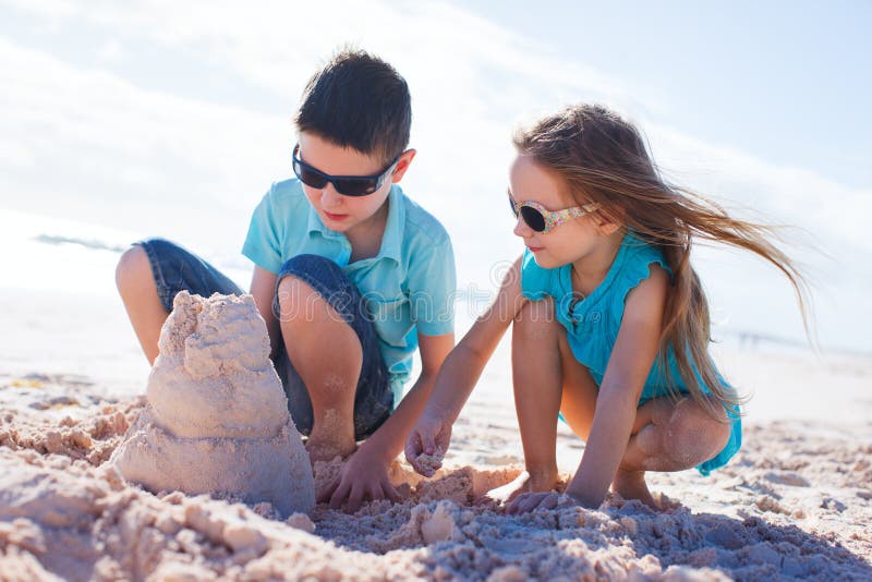 Two kids playing with sand stock photo. Image of brother - 38648414