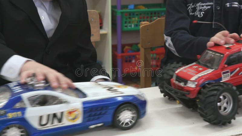 Two Kids Playing Toy Model Cars at the Table Stock Video - Video of ...