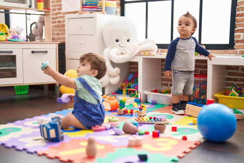 Two Kids Playing with Toys at Kindergarten Stock Photo - Image of floor ...