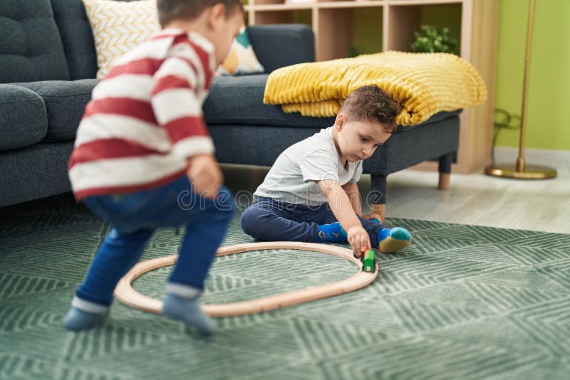 Two Kids Playing with Train Toy Sitting on Floor at Home Stock Photo ...