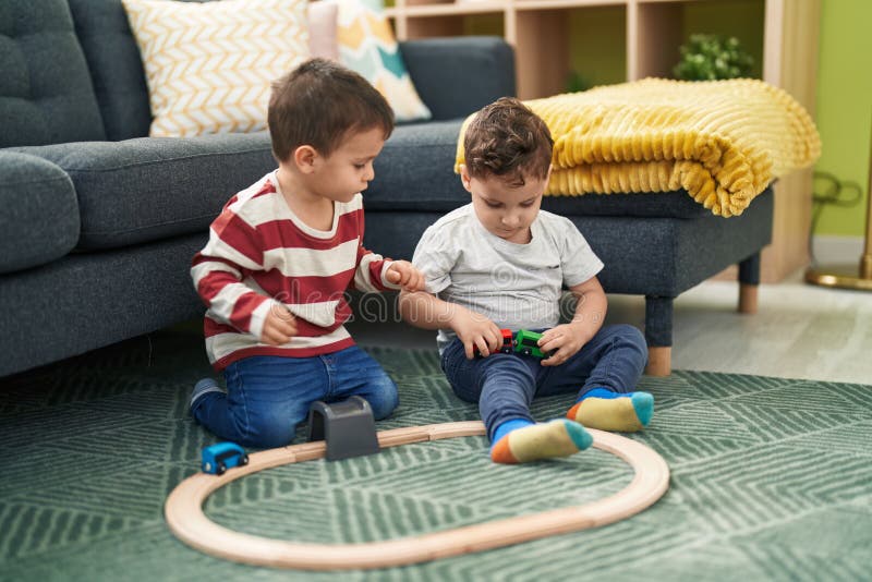 Two Kids Playing with Train Toy Sitting on Floor at Home Stock Image ...