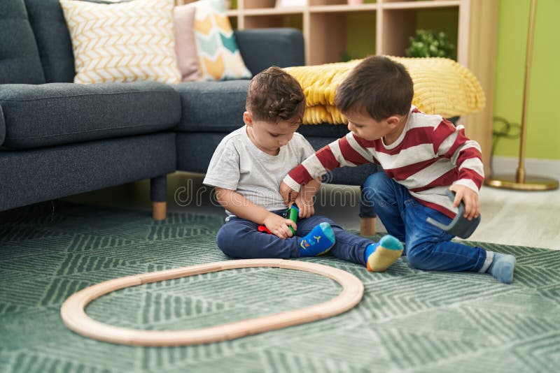 Two Kids Playing with Train Toy Sitting on Floor at Home Stock Image ...
