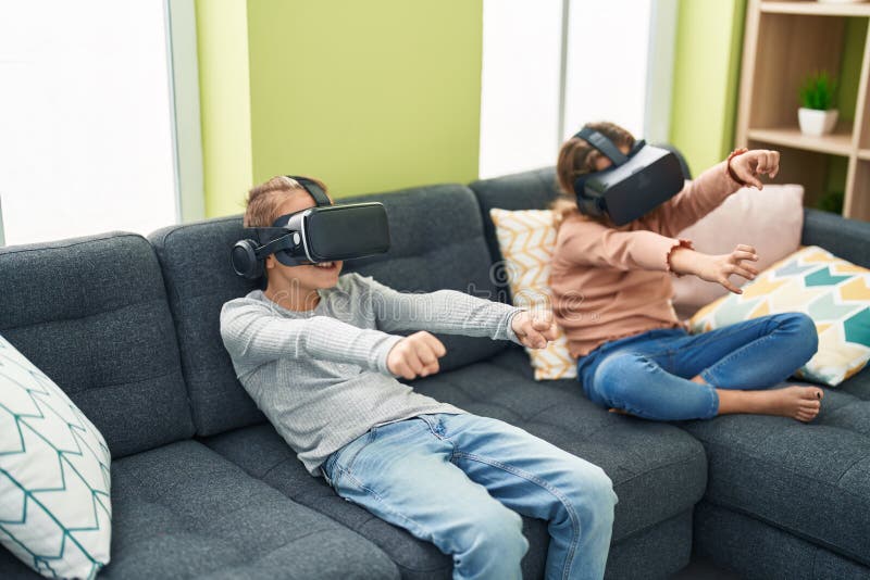 Two Kids Playing Video Game Using Virtual Reality Glasses at Home Stock ...
