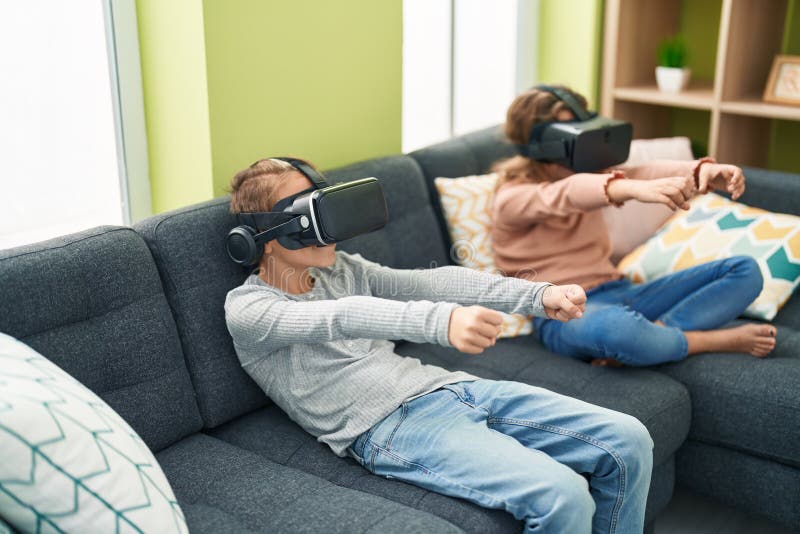 Two Kids Playing Video Game Using Virtual Reality Glasses at Home Stock ...