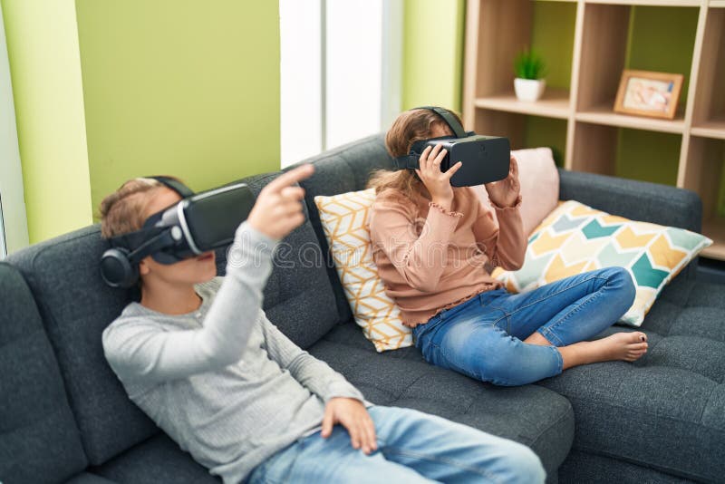 Two Kids Playing Video Game Using Virtual Reality Glasses at Home Stock ...