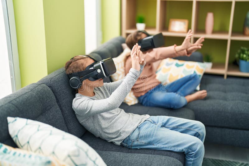 Two Kids Playing Video Game Using Virtual Reality Glasses at Home Stock ...