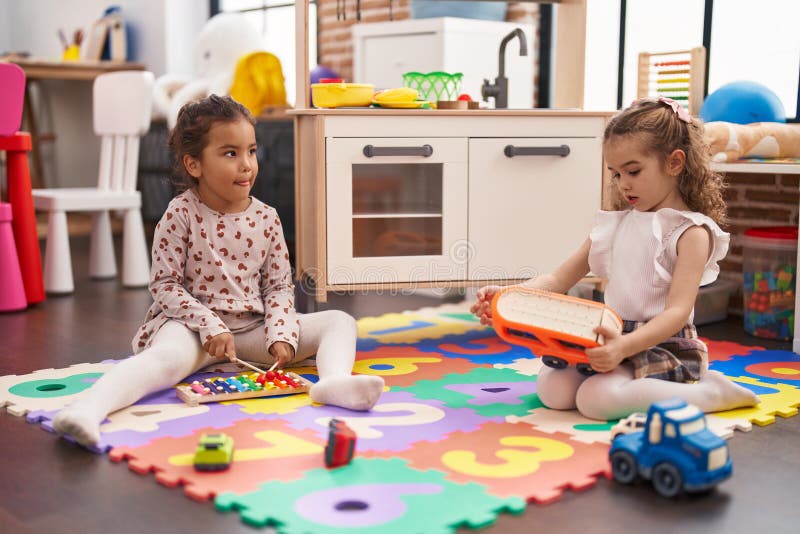 Two Kids Playing Xylophone Sitting on Floor at Kindergarten Stock Image ...