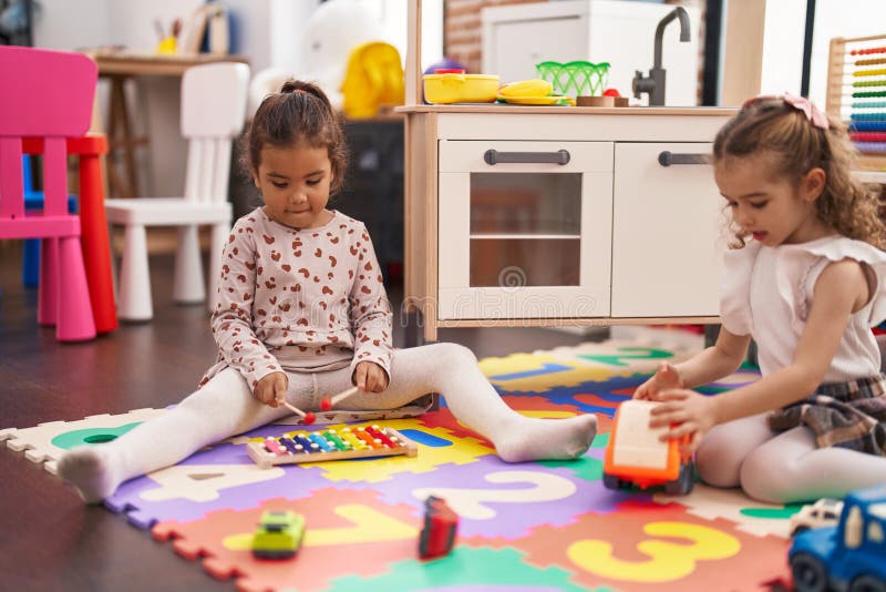 Two Kids Playing Xylophone Sitting on Floor at Kindergarten Stock Image ...