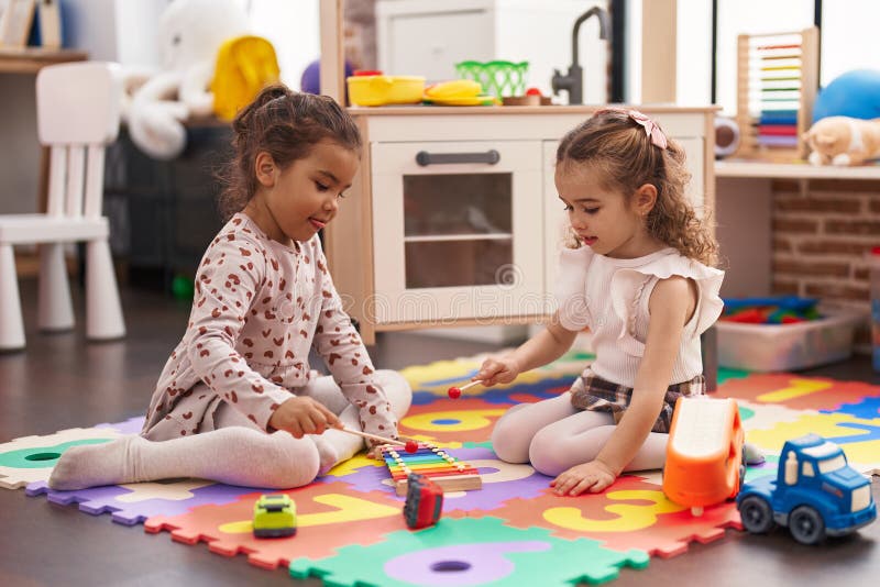 Two Kids Playing Xylophone Sitting on Floor at Kindergarten Stock Photo ...