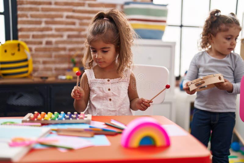 Two Kids Playing Xylophone Sitting on Table at Kindergarten Stock Photo ...