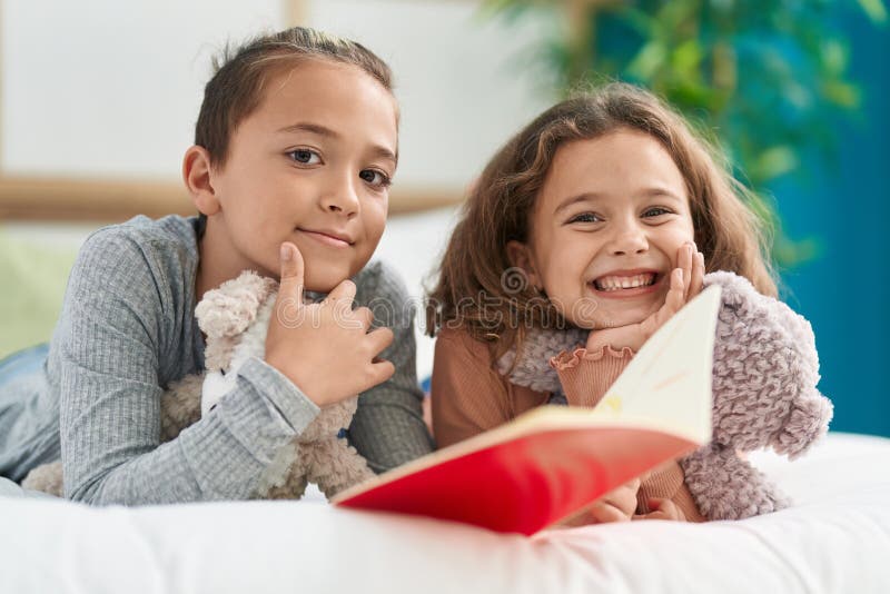 Two Kids Reading Story Book Lying on Bed at Bedroom Stock Photo - Image ...