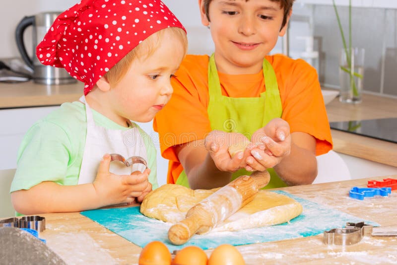 Two Kids Roll Dough and Cut Shapes on the Kitchen Stock Photo - Image ...